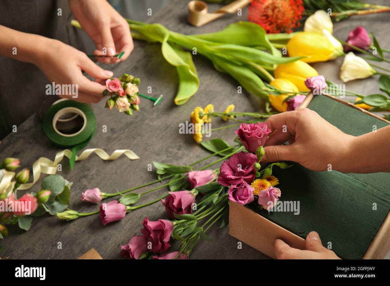 Female hands making beautiful flower composition in floral shop Stock ...