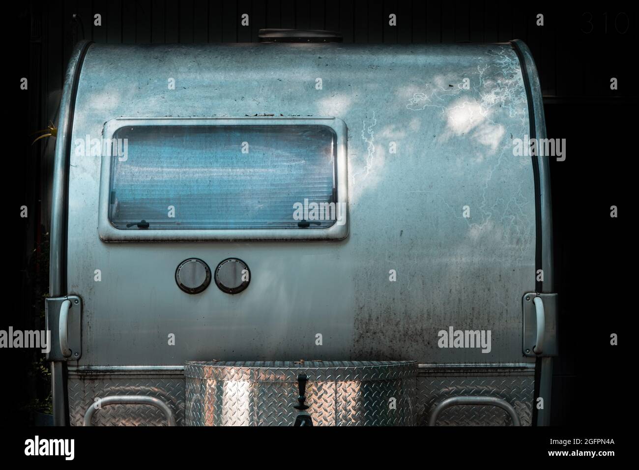Classic retro chrome and aluminum camper with some grime and dirt in ...