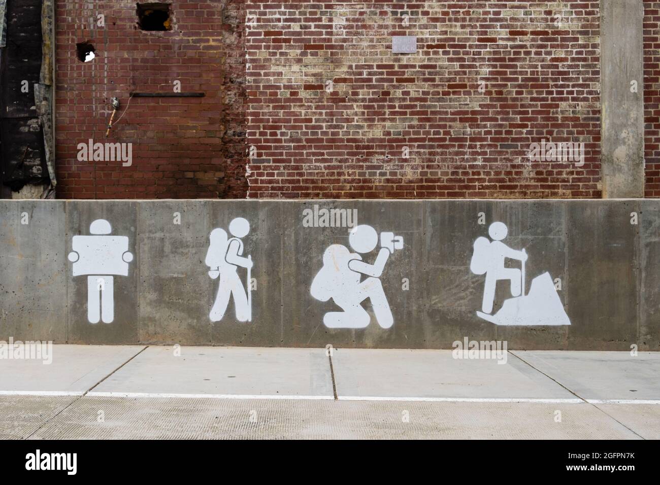 Outdoor activity pictograph spray painted on cement wall at Camp North ...