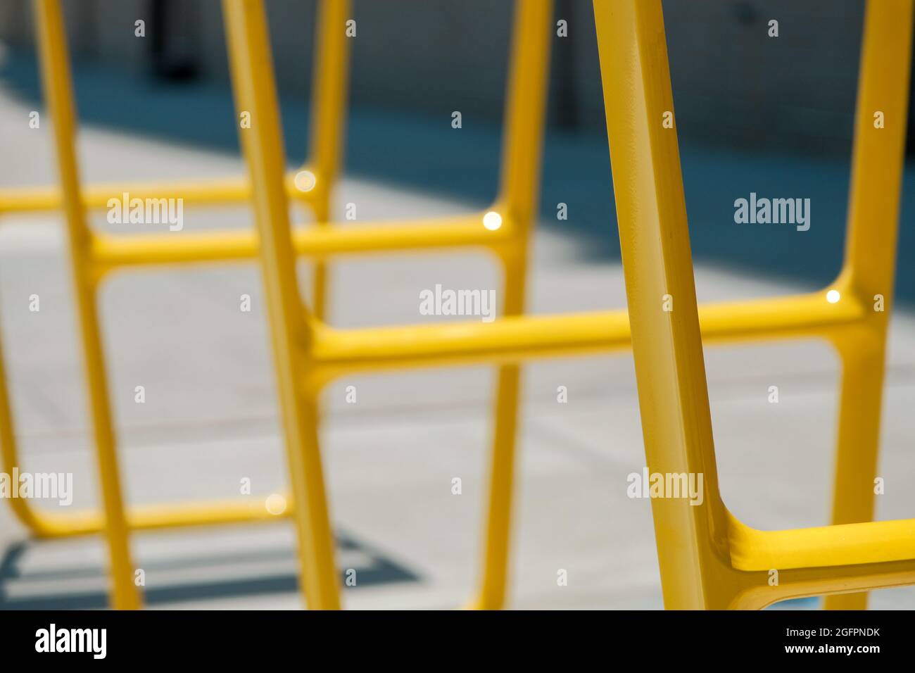 Brightly painted yellow metal bicycle rack on sidewalk in Charlotte ...