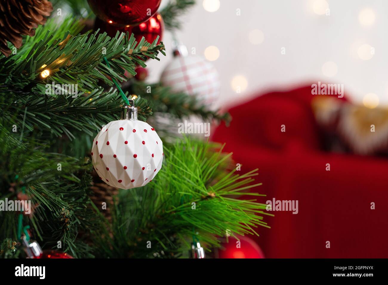 Red and white baubles hanging from a Christmas tree close up Stock ...