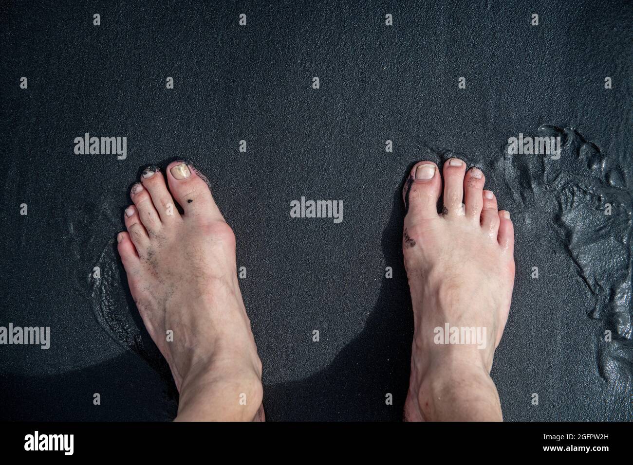 Feet on black sand. - Puerto Rico Stock Photo - Alamy