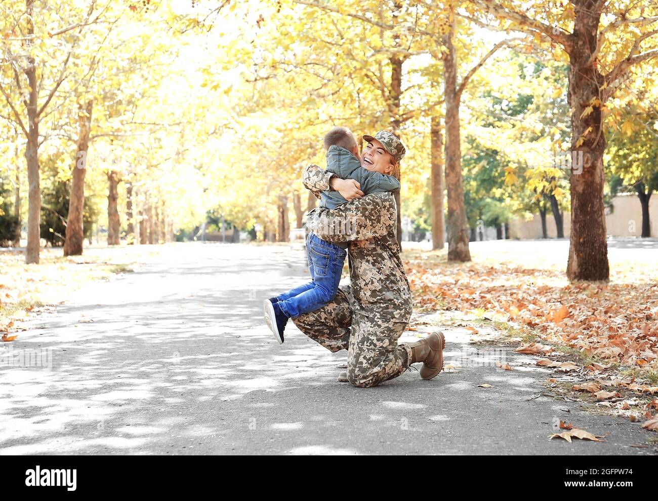 Mother soldier and little kid embracing in the park Stock Photo - Alamy