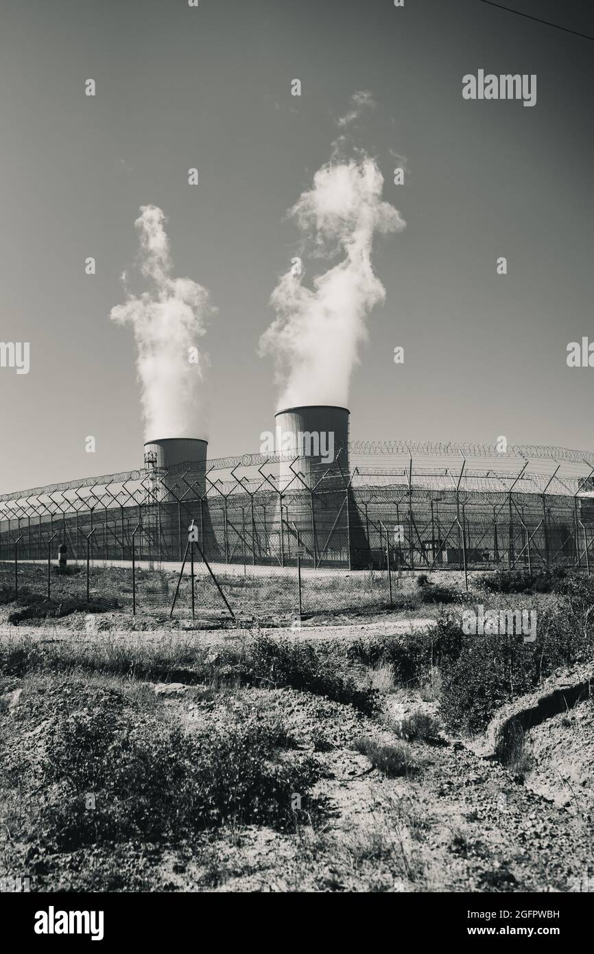 Greyscale view of the factory working and smoke coming out of it Stock ...