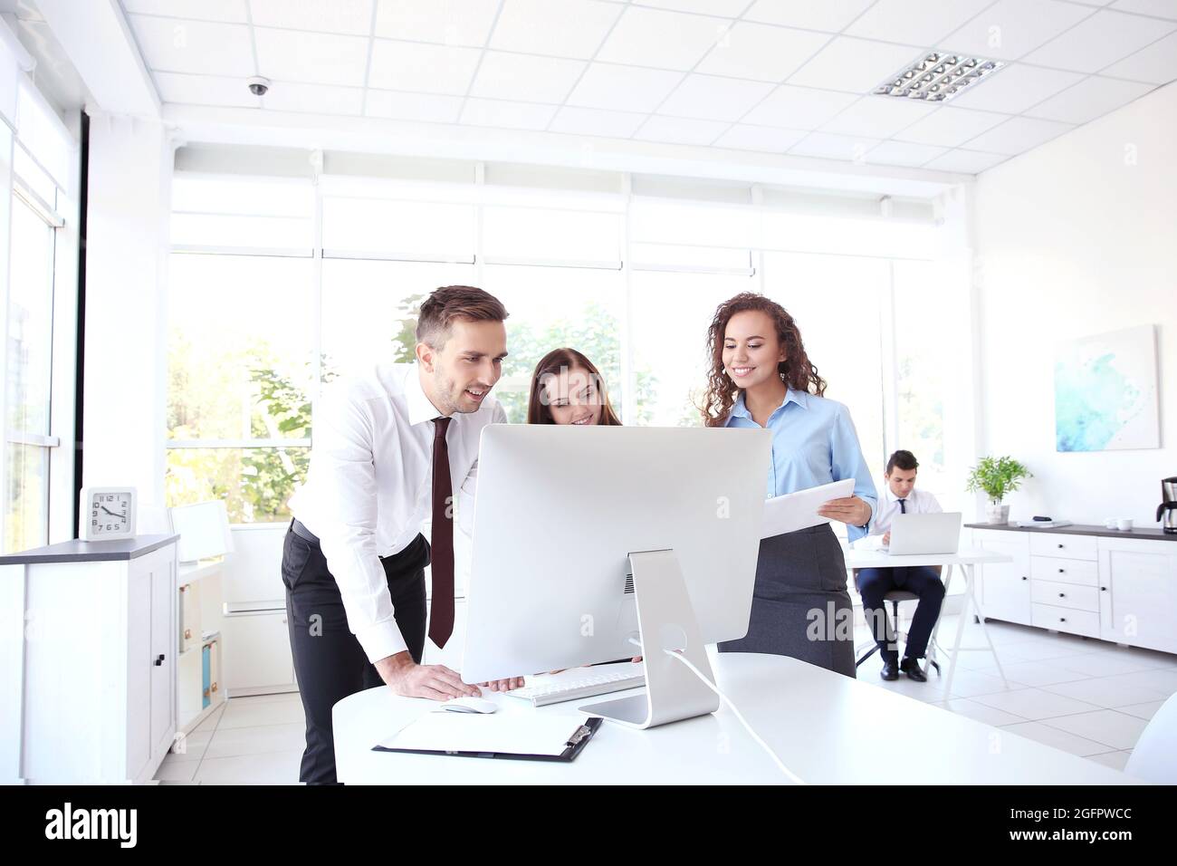 Business training concept. Colleagues looking at computer monitor in ...