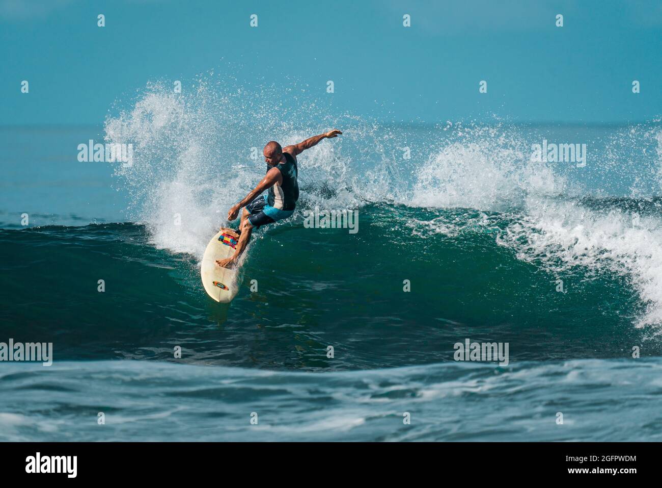 A very fot senior man (over 50 years old) showing exceptional surfing ...