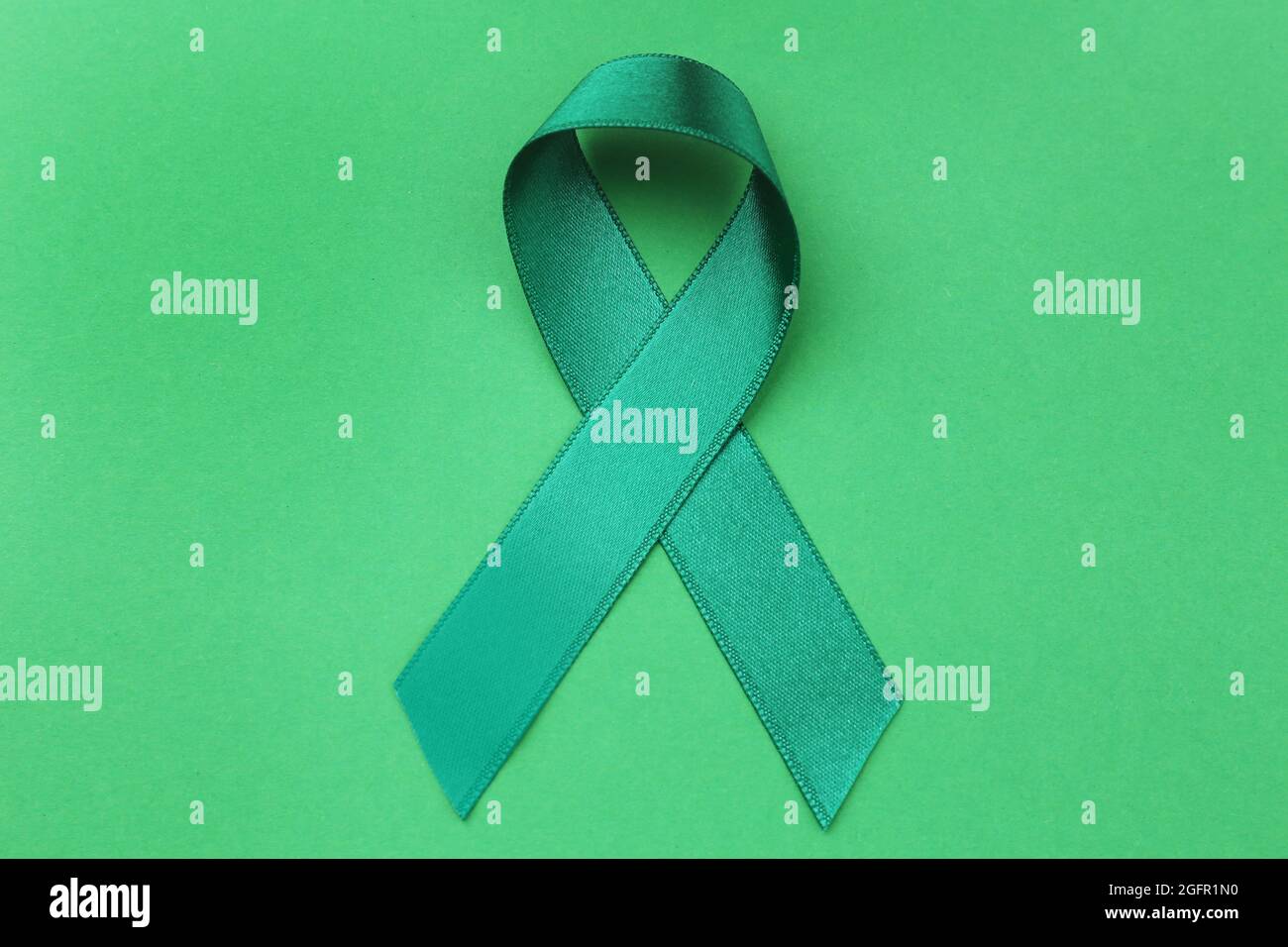 Green ribbon on color background. Mitochondrial diseases and kidney ...