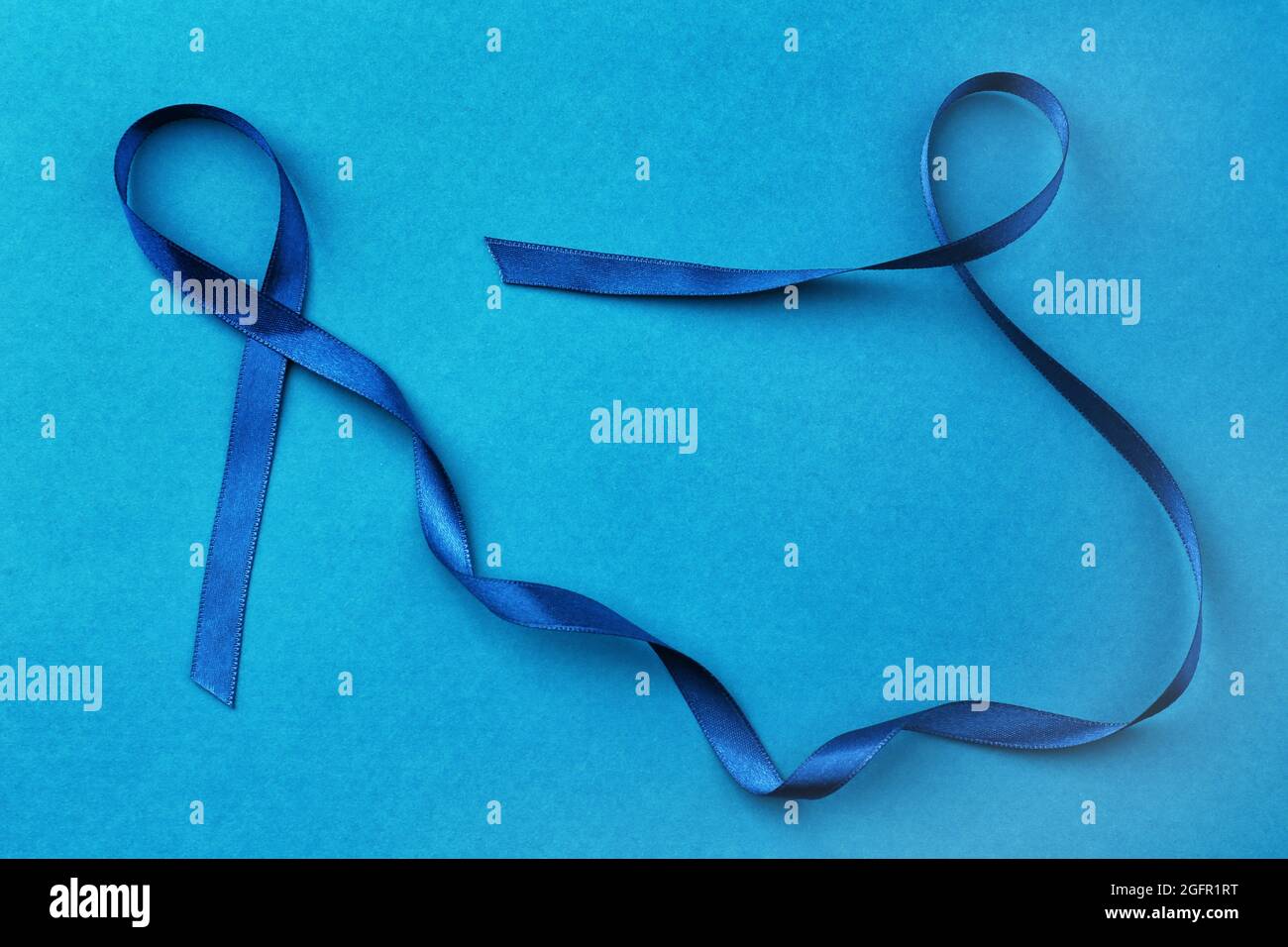 Sea-green ribbon on color background. Ovarian cancer and gynecological ...