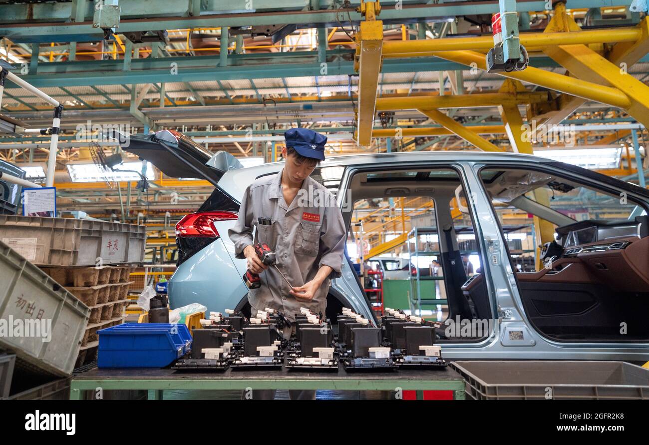 Workers assemble cars produced at a factory of Haima Automobile in ...