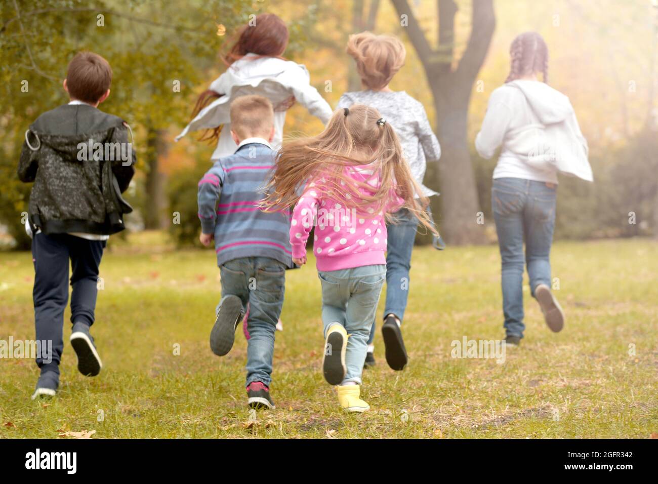 Sporty children running in the park Stock Photo - Alamy