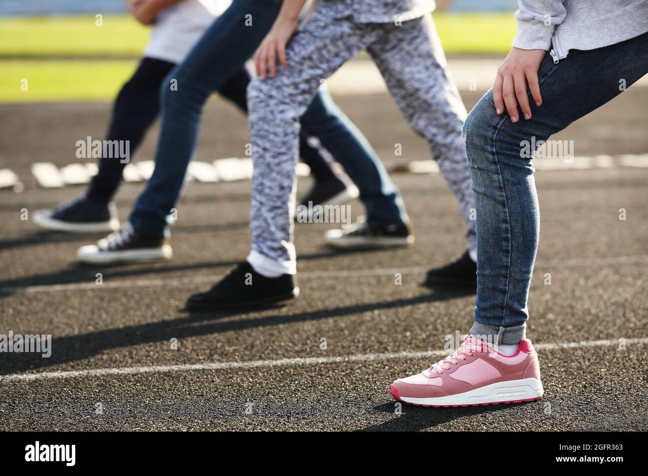 Children in ready position to run on track, closeup Stock Photo - Alamy
