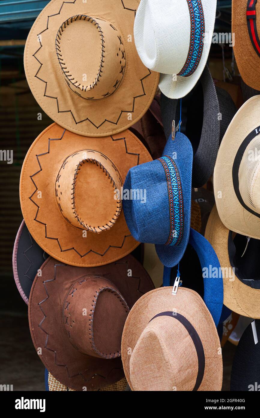 Shop with hats of various styles in the street market. Showcase with ...