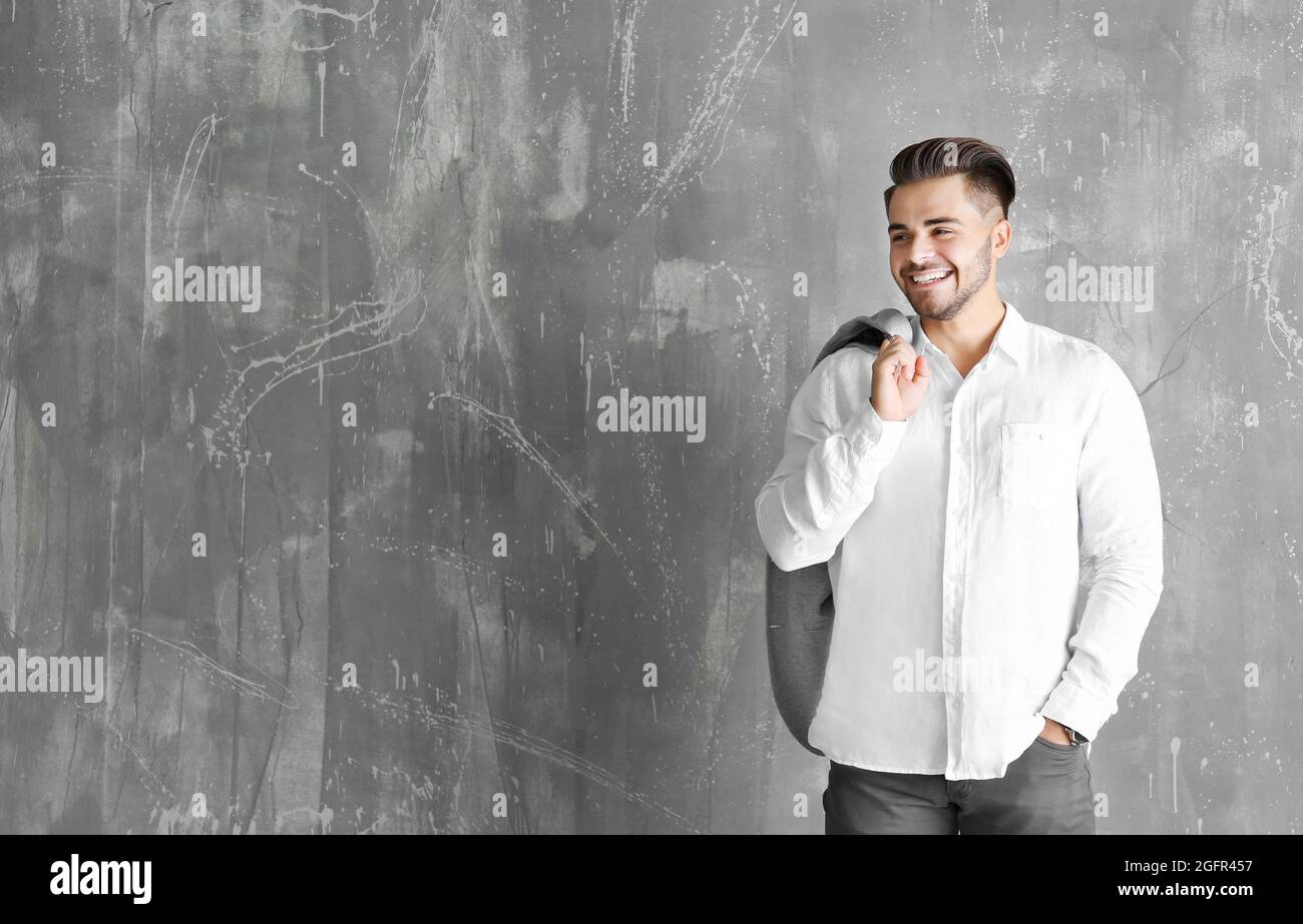 Handsome man on wall background Stock Photo - Alamy