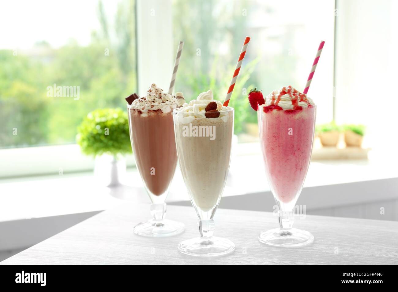 Delicious milkshakes on table in kitchen Stock Photo - Alamy