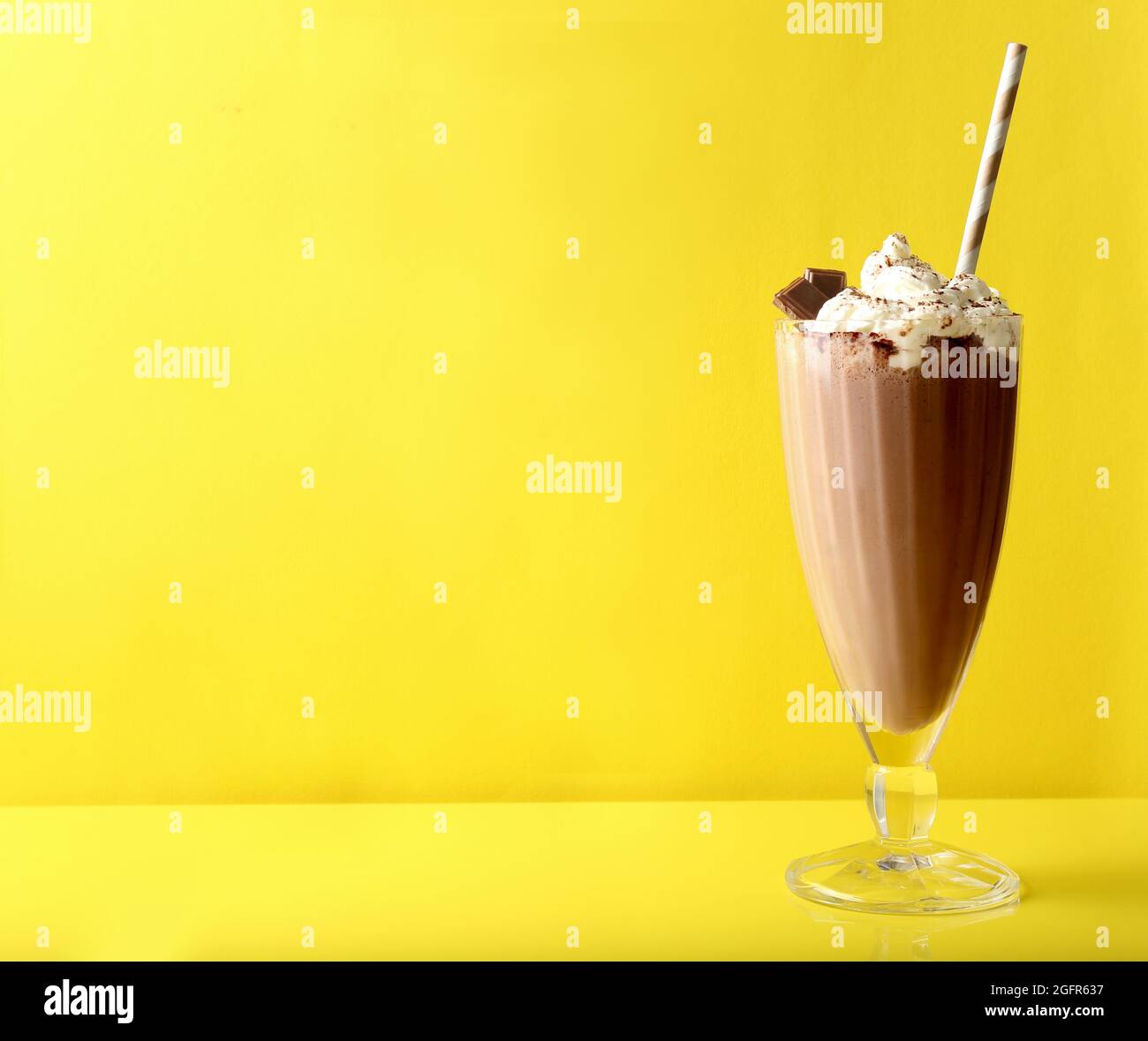 Delicious milkshake on yellow background Stock Photo - Alamy