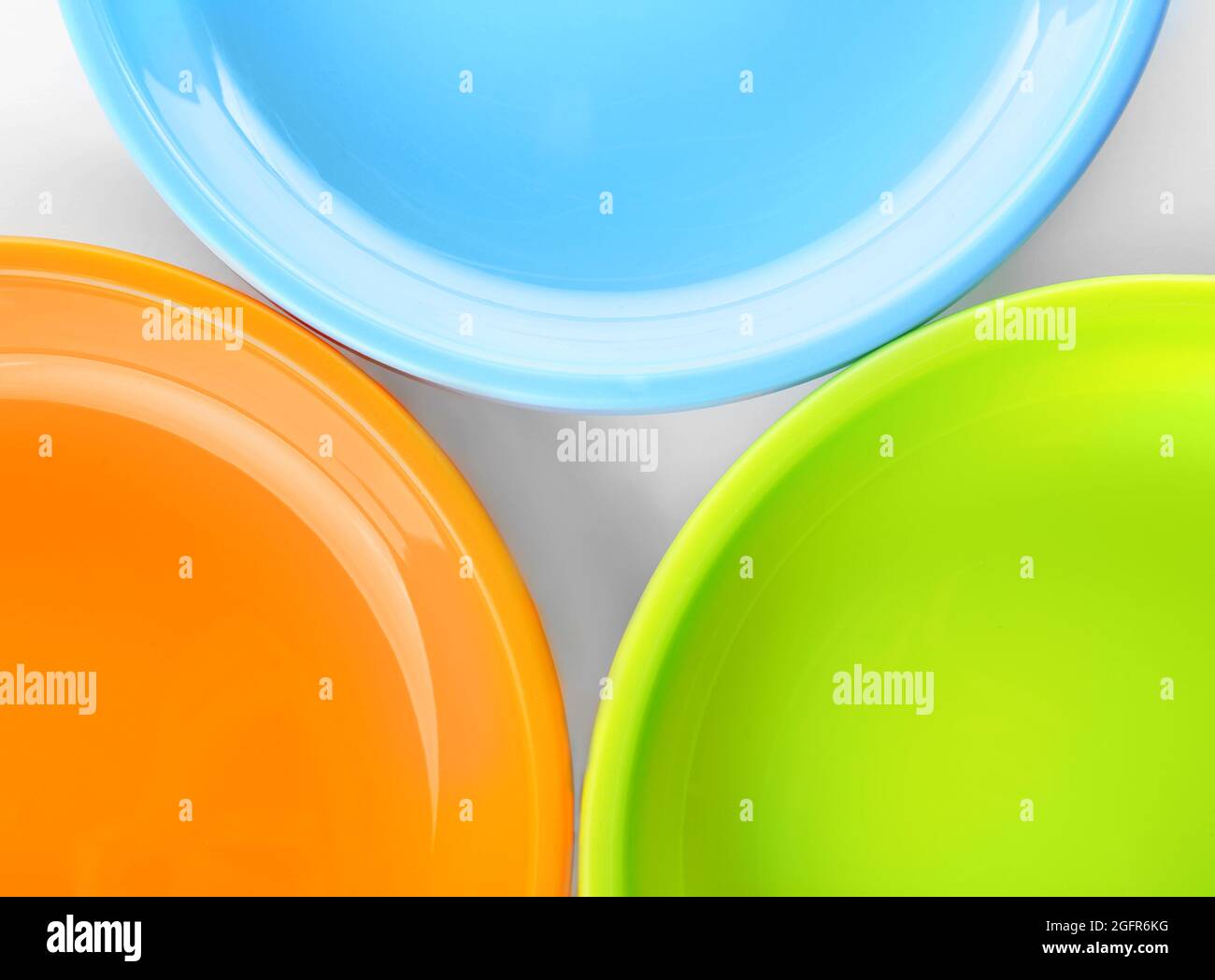 Colorful plastic plates for child, closeup Stock Photo - Alamy