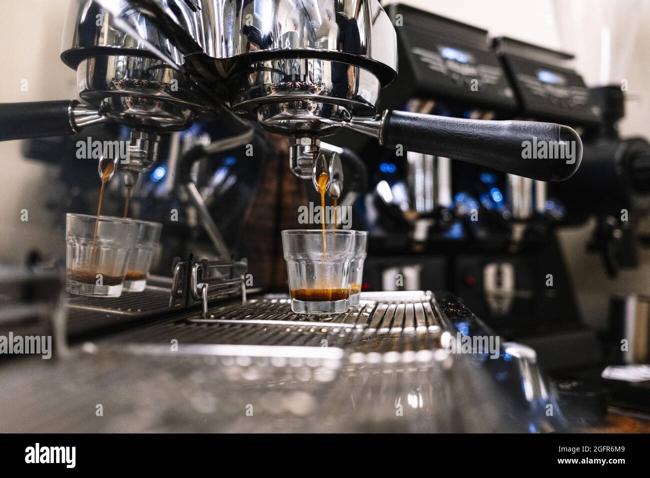 Closeup shot of espresso-making process with coffee cup under ...
