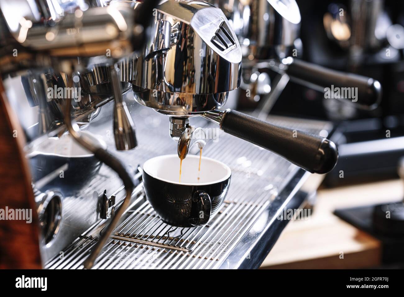 Closeup shot of espresso-making process with coffee cup under ...