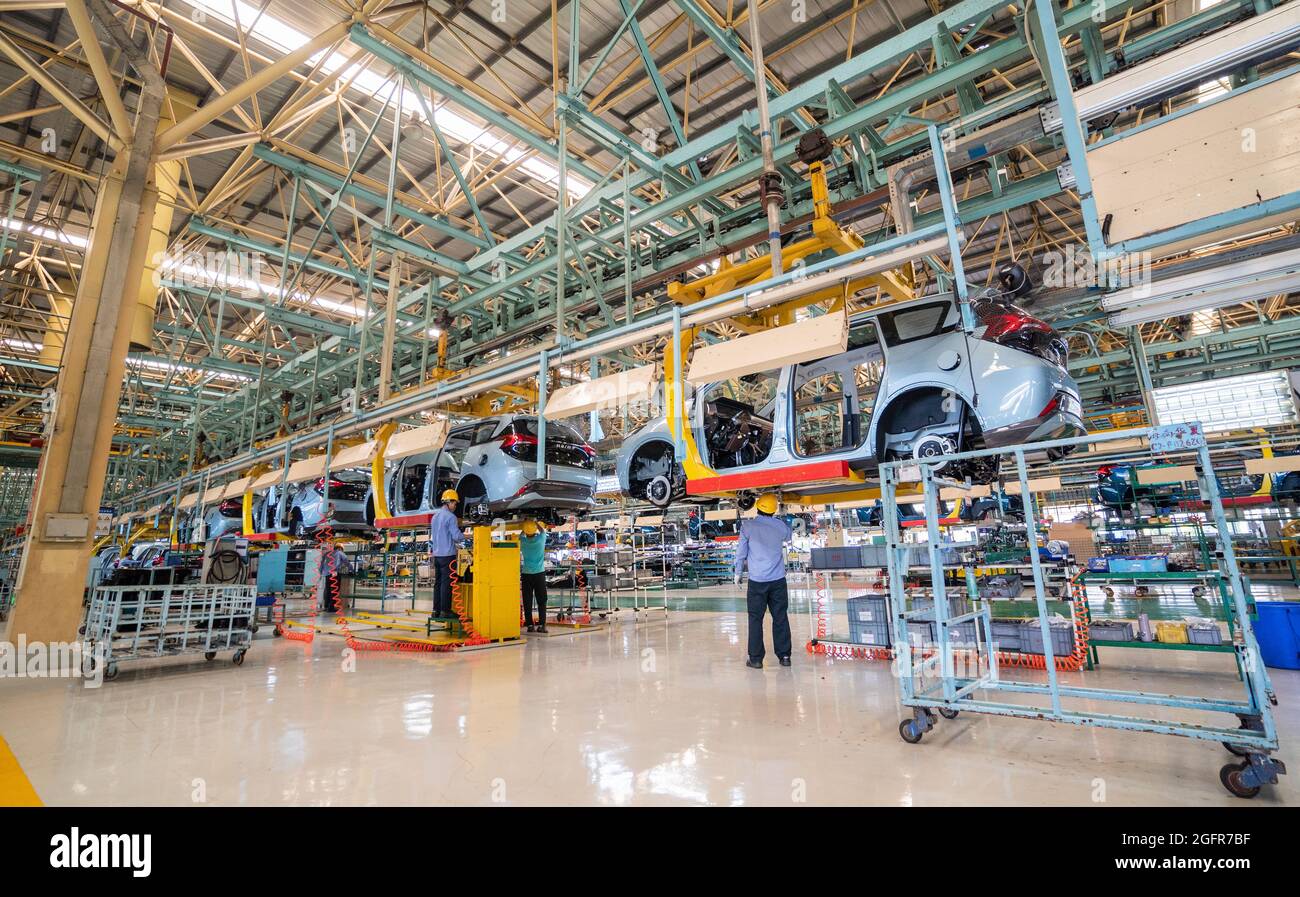 Workers assemble cars produced at a factory of Haima Automobile in ...