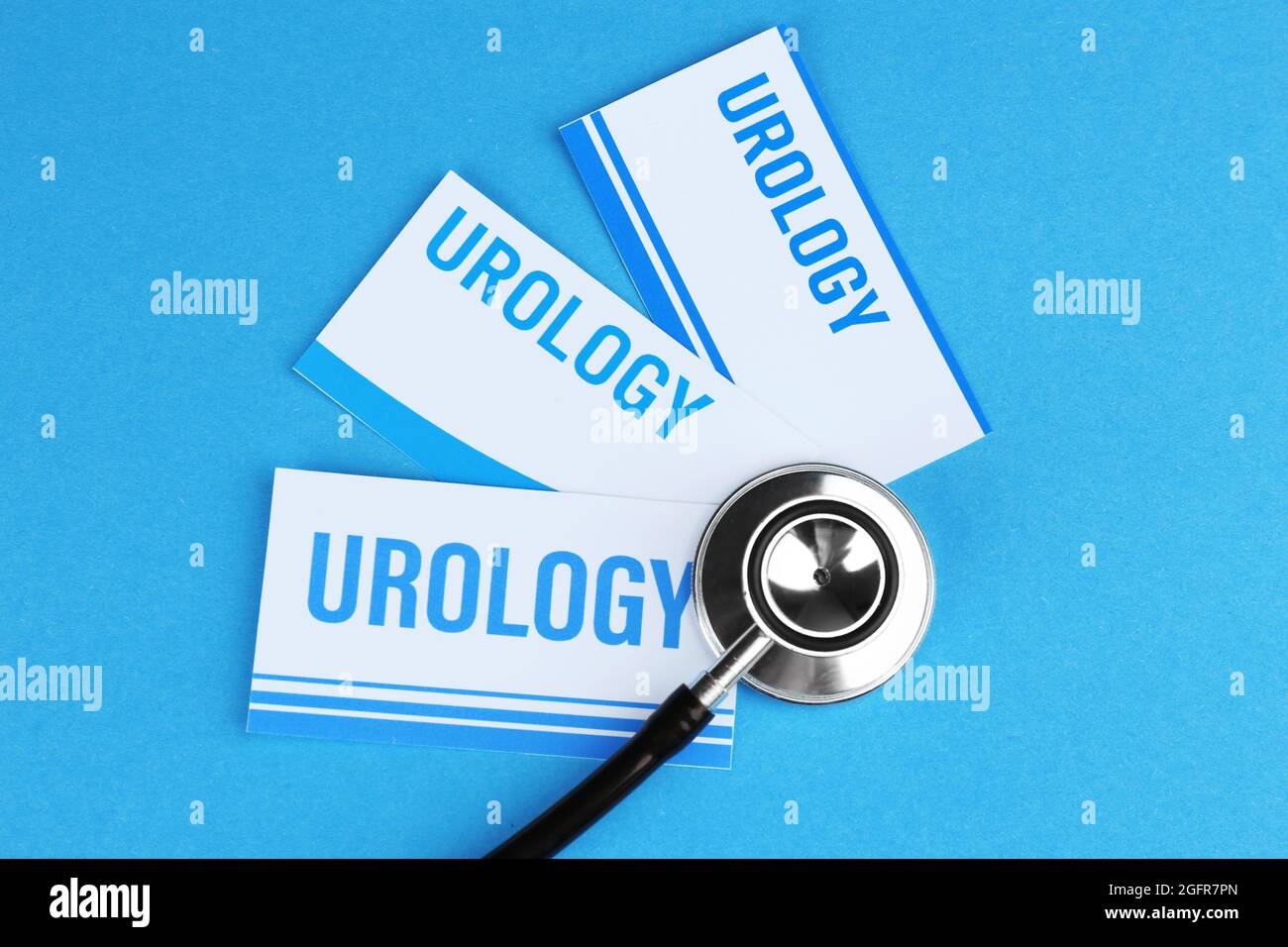 Medical stethoscope and cards with word UROLOGY on blue background ...