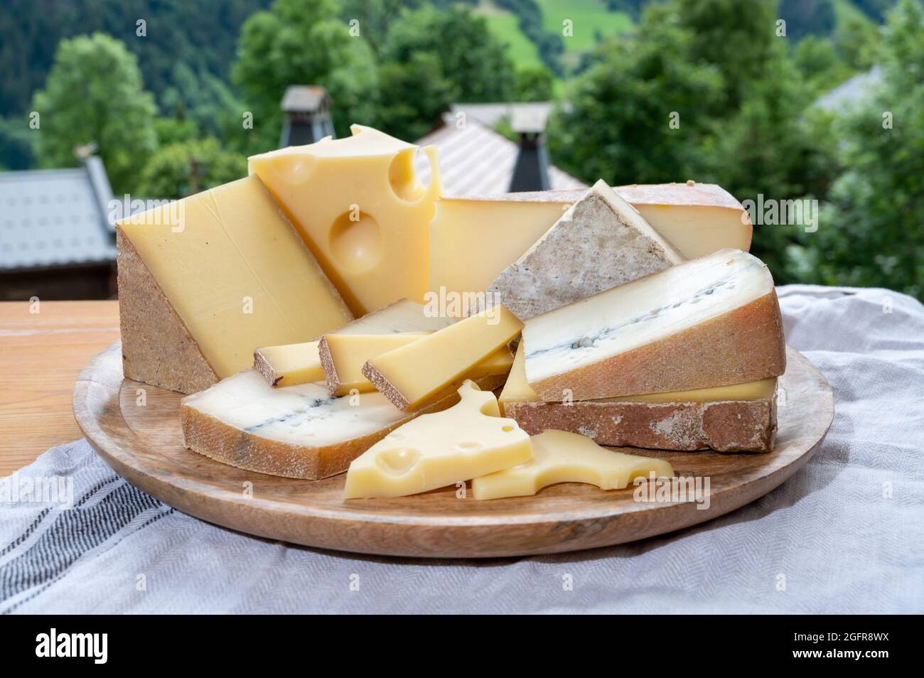 Cheese collection, wooden board with French cheeses comte, beaufort ...