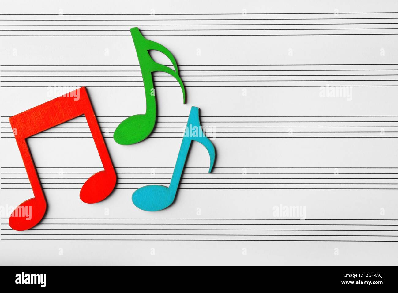 Colourful wooden musical notes on music sheet background Stock Photo ...