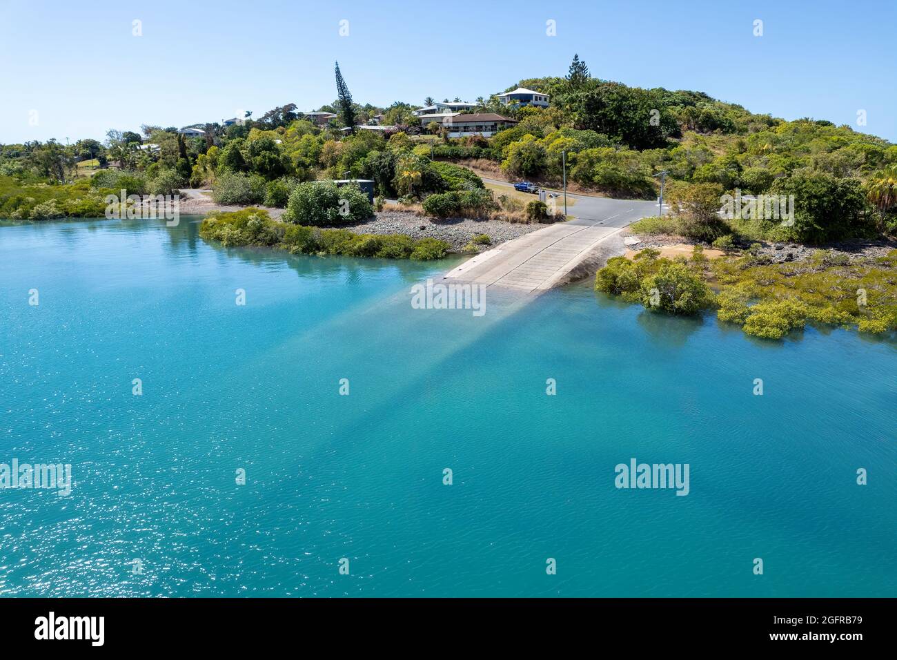 Drone aerial towards a boat ramp in a small seaside community on the ...