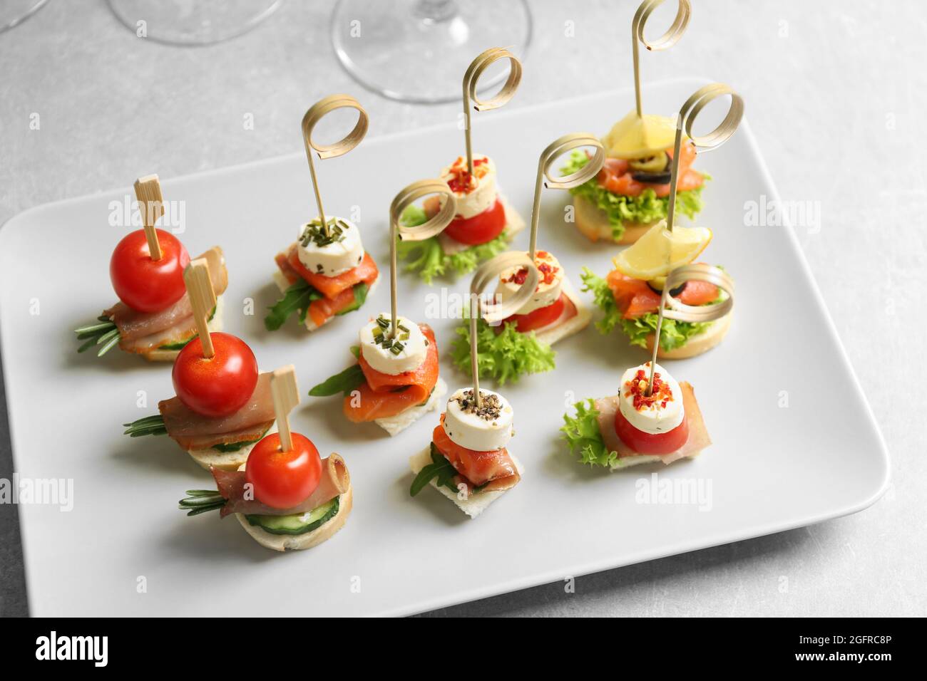 Assorted canapes on table closeup Stock Photo - Alamy