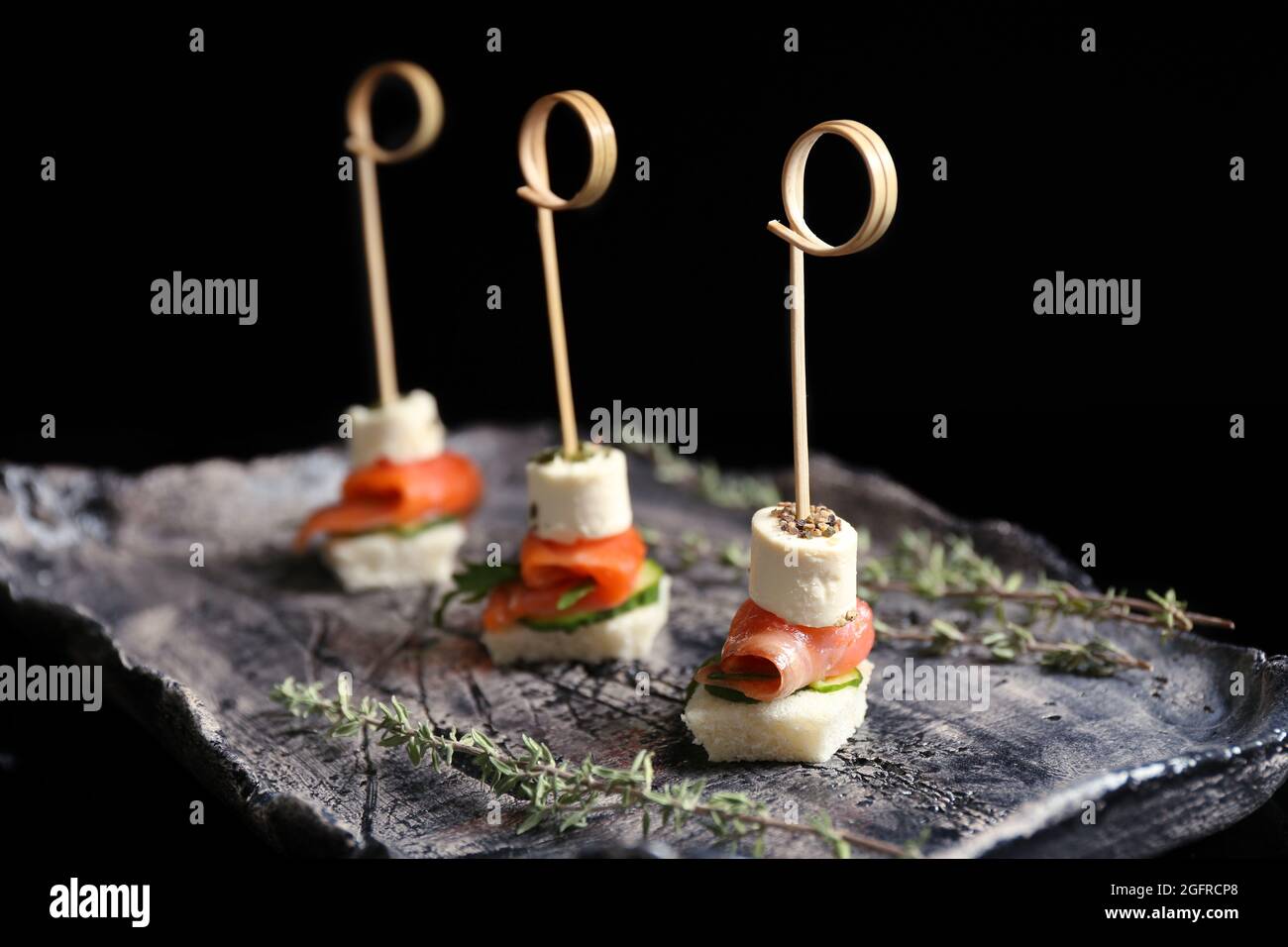 Delicious canapes on black background Stock Photo - Alamy