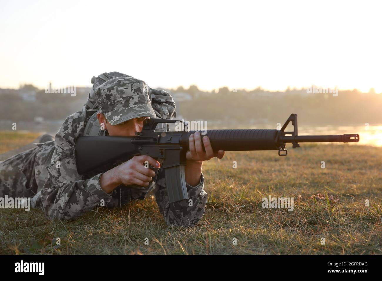 Soldier in camouflage taking aim at military firing range Stock Photo ...