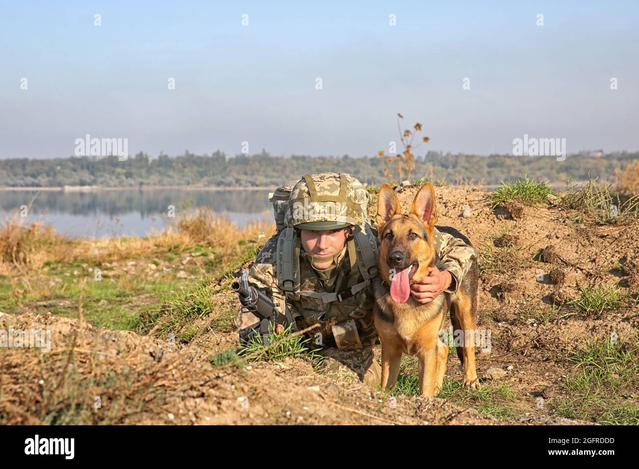 Soldier with german shepherd dog at military firing range Stock Photo ...