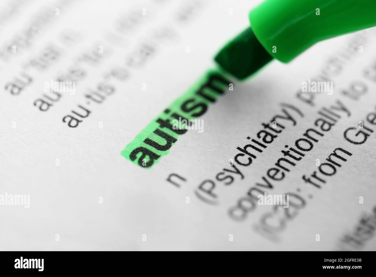 Highlighted in green word AUTISM on page of dictionary Stock Photo - Alamy