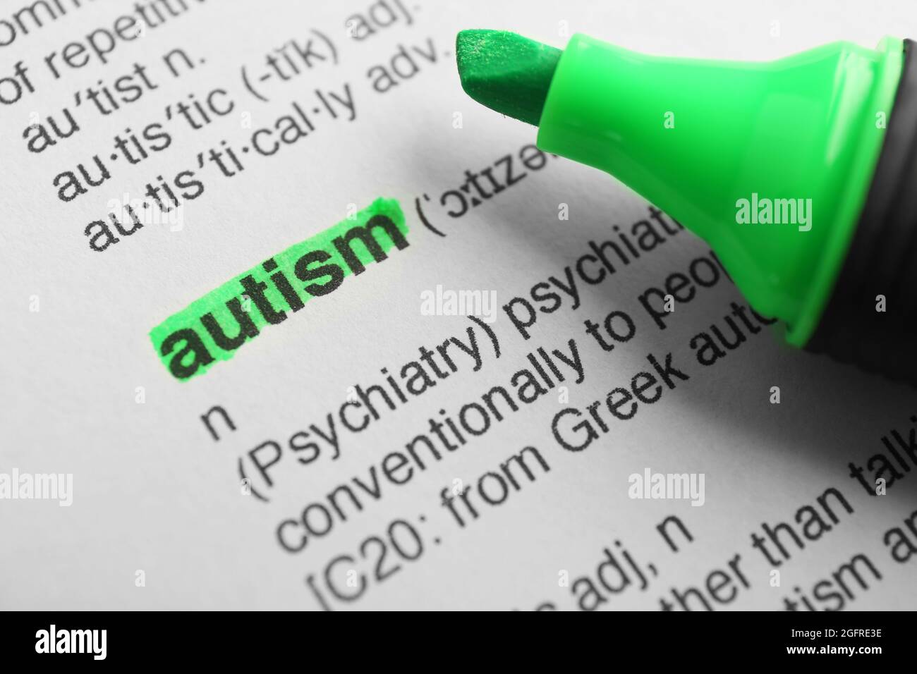 Highlighted in green word AUTISM on page of dictionary Stock Photo - Alamy