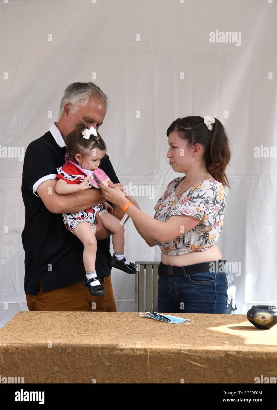 Native American potter Russell Sanchez holds his daughter's child in ...