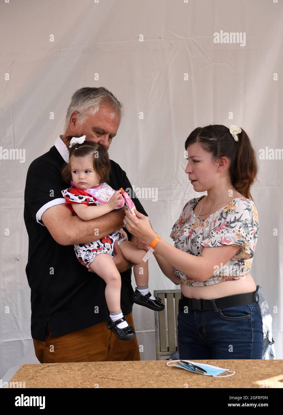 Native American potter Russell Sanchez holds his daughter's child in ...