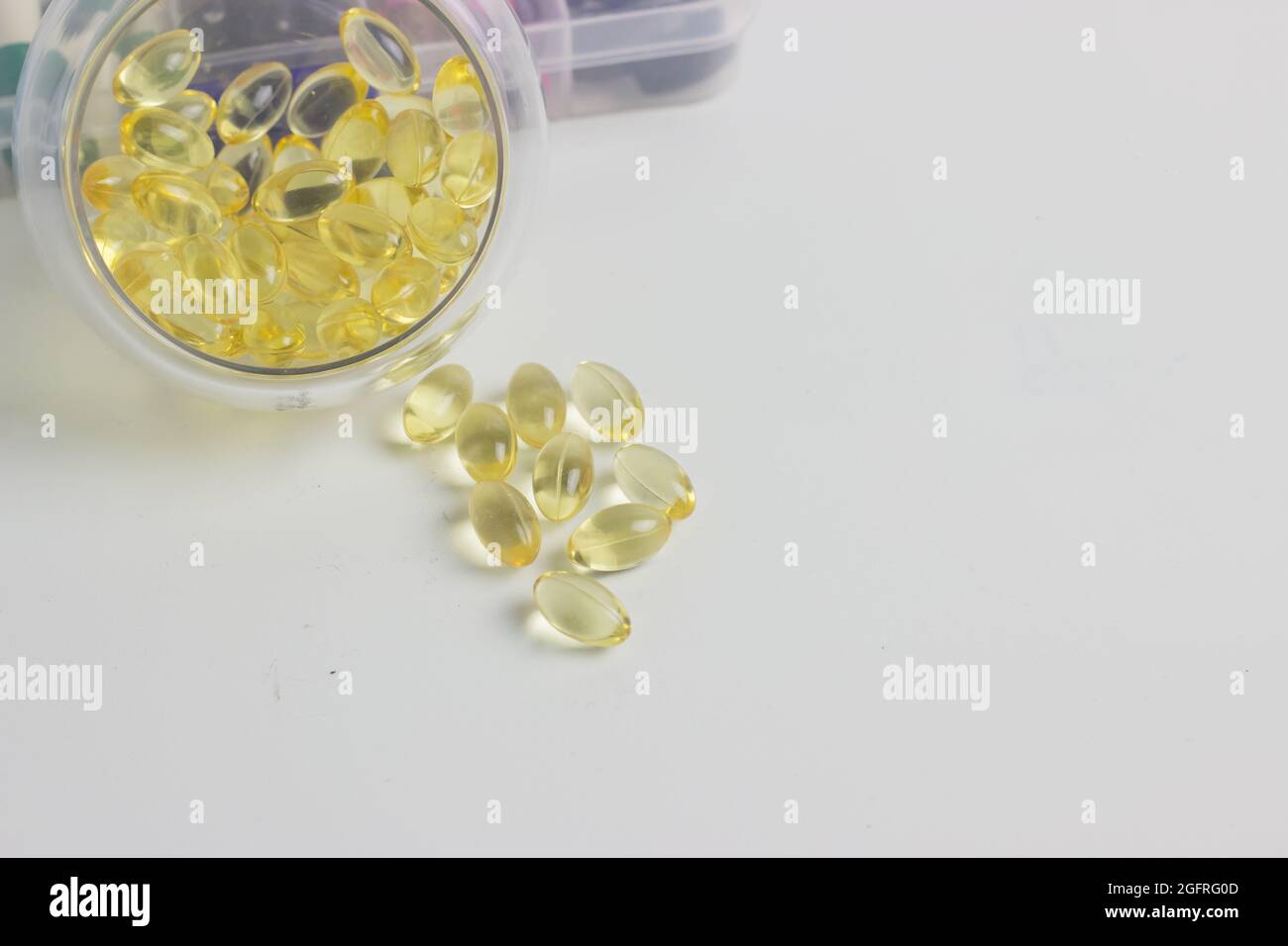 fish oils omega 3 multivitamin source soft gels with white background ...