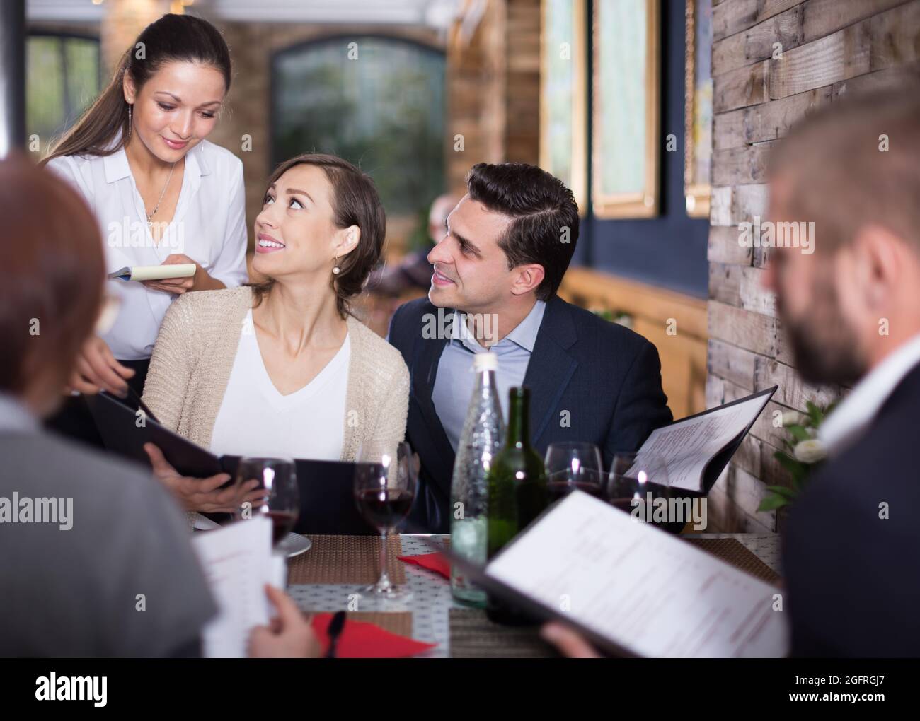 girl the waiter recommends dishes to guests Stock Photo - Alamy