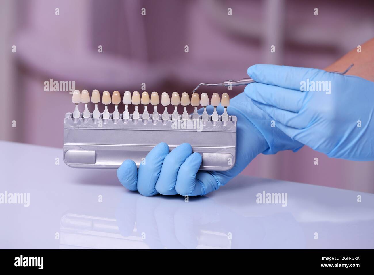 Dentist working with artificial teeth in laboratory Stock Photo - Alamy