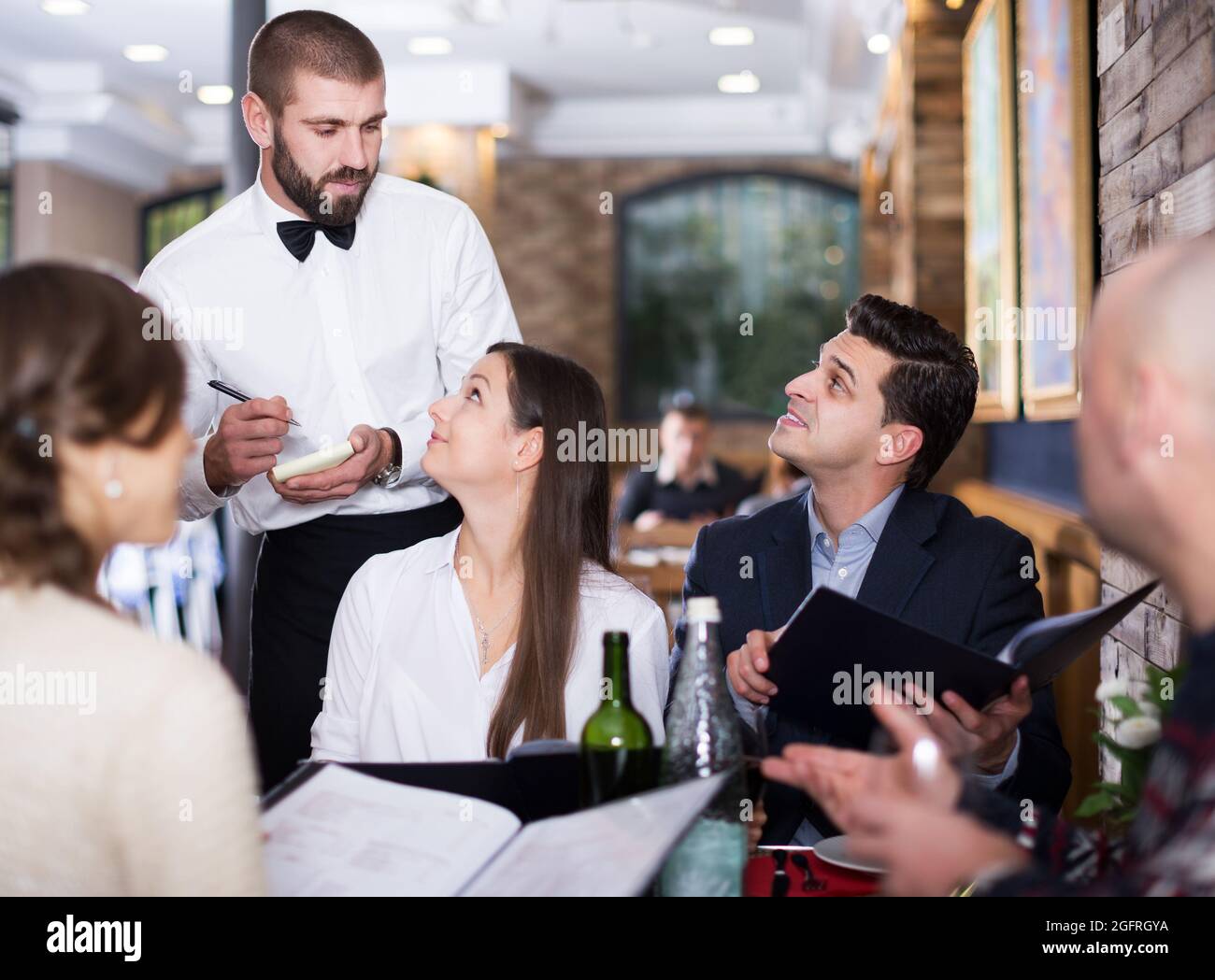 Employee waiter man taking order from guests Stock Photo - Alamy
