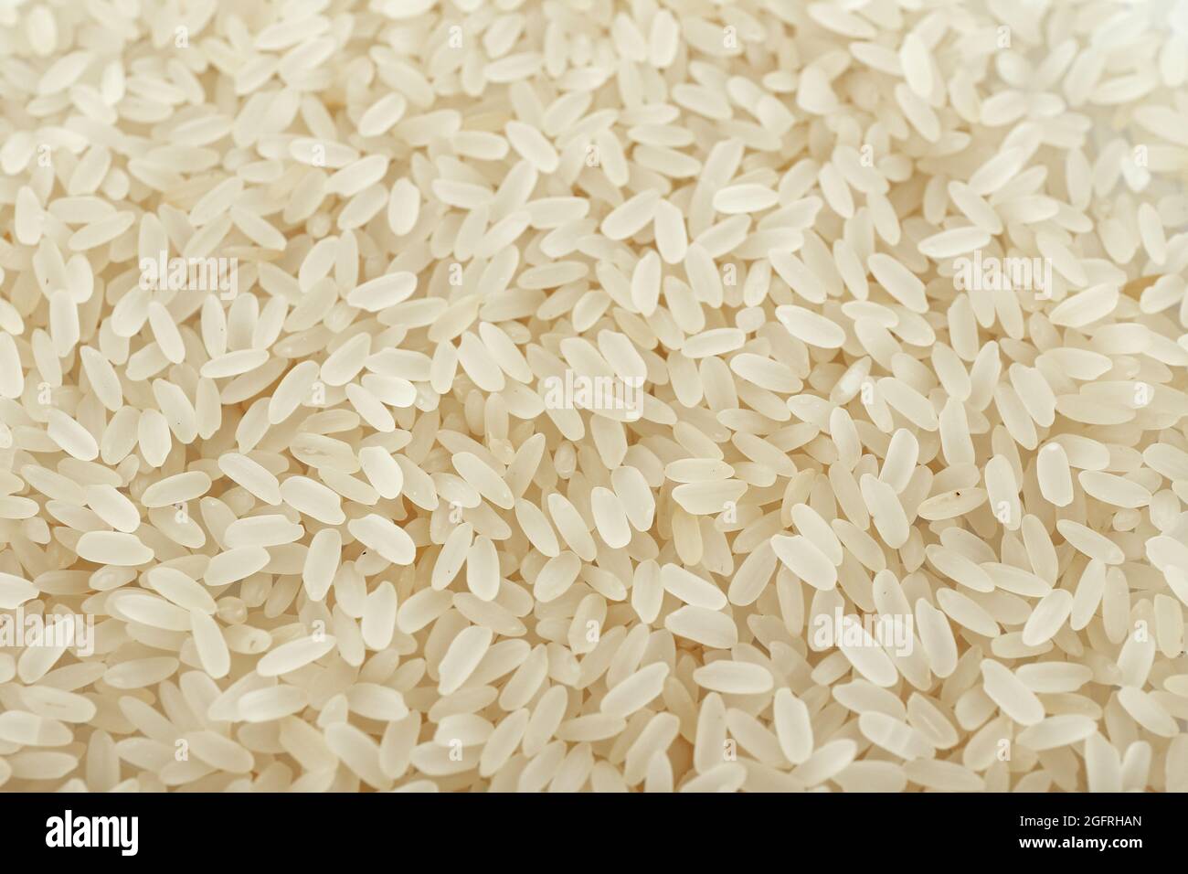 Parboiled long grain rice background Stock Photo - Alamy