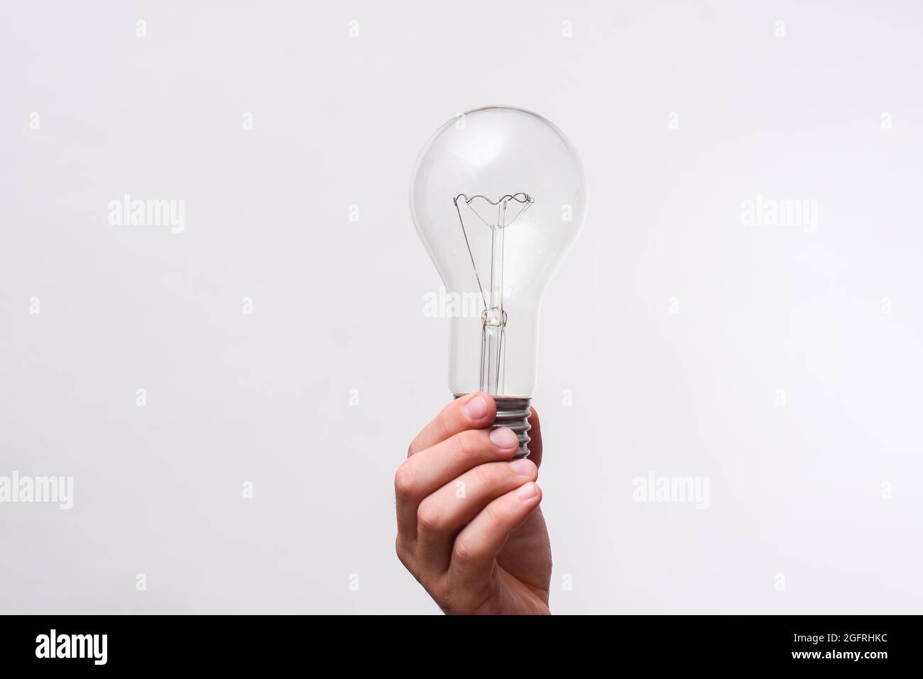 incandescent bulb in hand on a white background. mock up Stock Photo ...