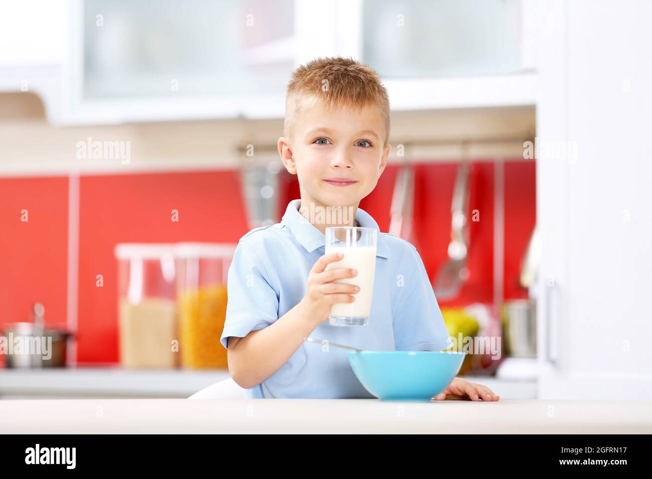 Little boy having breakfast in the kitchen Stock Photo - Alamy