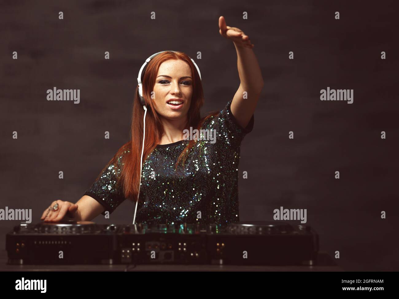 Beautiful female dj mixing music on dark background Stock Photo - Alamy