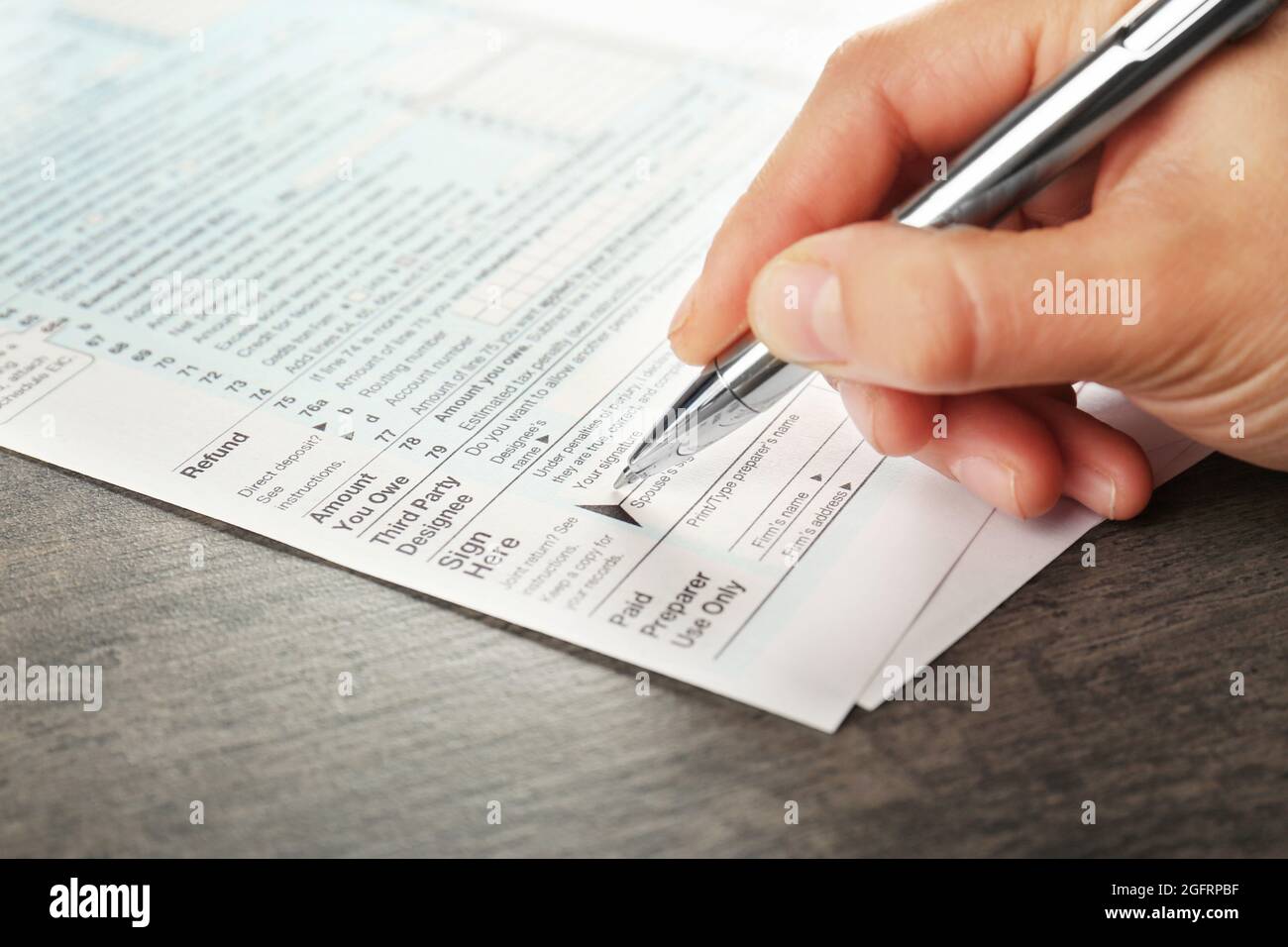 Woman filling individual income tax return form, closeup Stock Photo ...