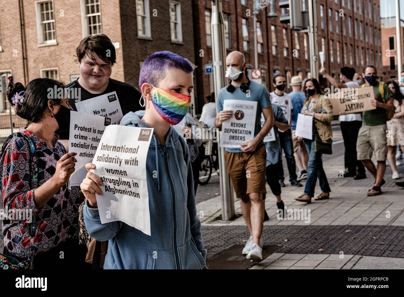Protesters hold placards during the demonstration.Dozens of people ...