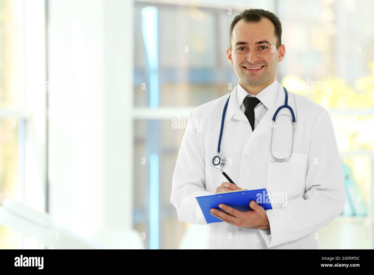 Doctor with clipboard at hospital Stock Photo - Alamy
