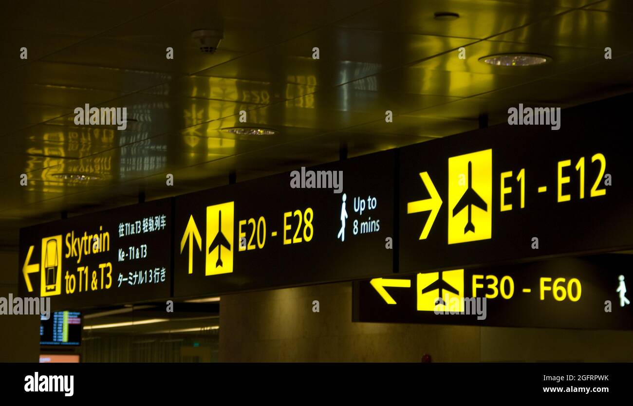 Signs and direction arrows on airport Stock Photo - Alamy