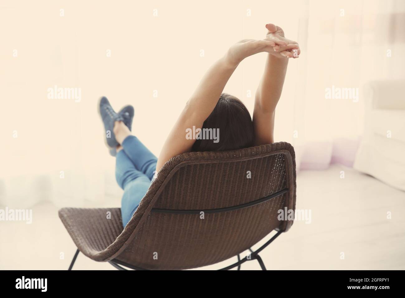 Beautiful girl relaxing on chair Stock Photo - Alamy