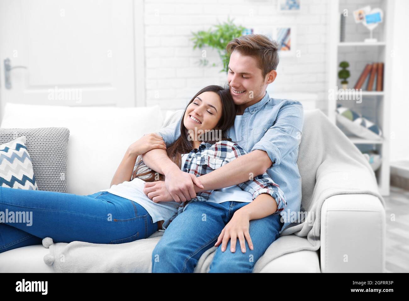Lovely couple relaxing on couch Stock Photo - Alamy
