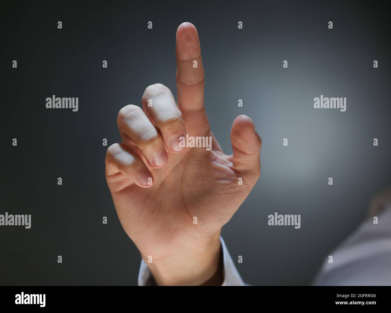 Businessman hand pointing, dark background Stock Photo - Alamy